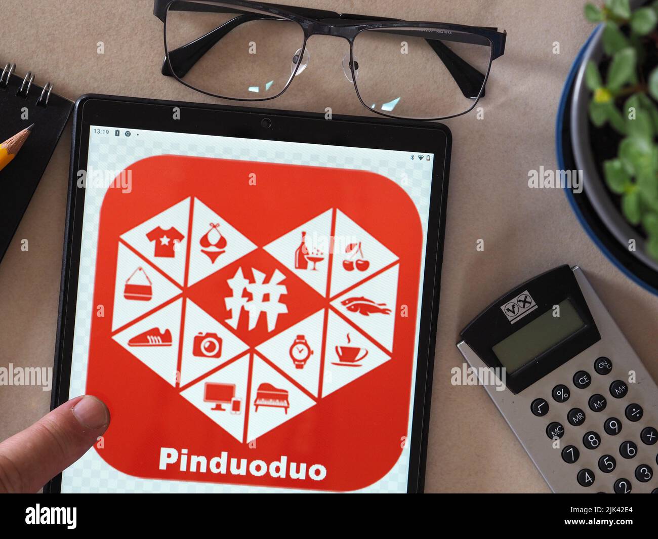 In this photo illustration, a Pinduoduo Inc. logo seen displayed on a ...