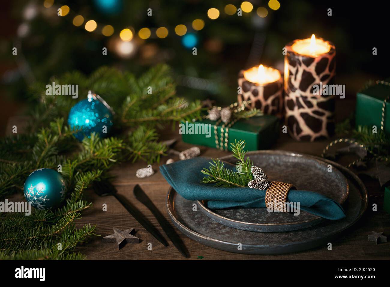 Christmas table setting with empty black ceramic plate, fir tree ...