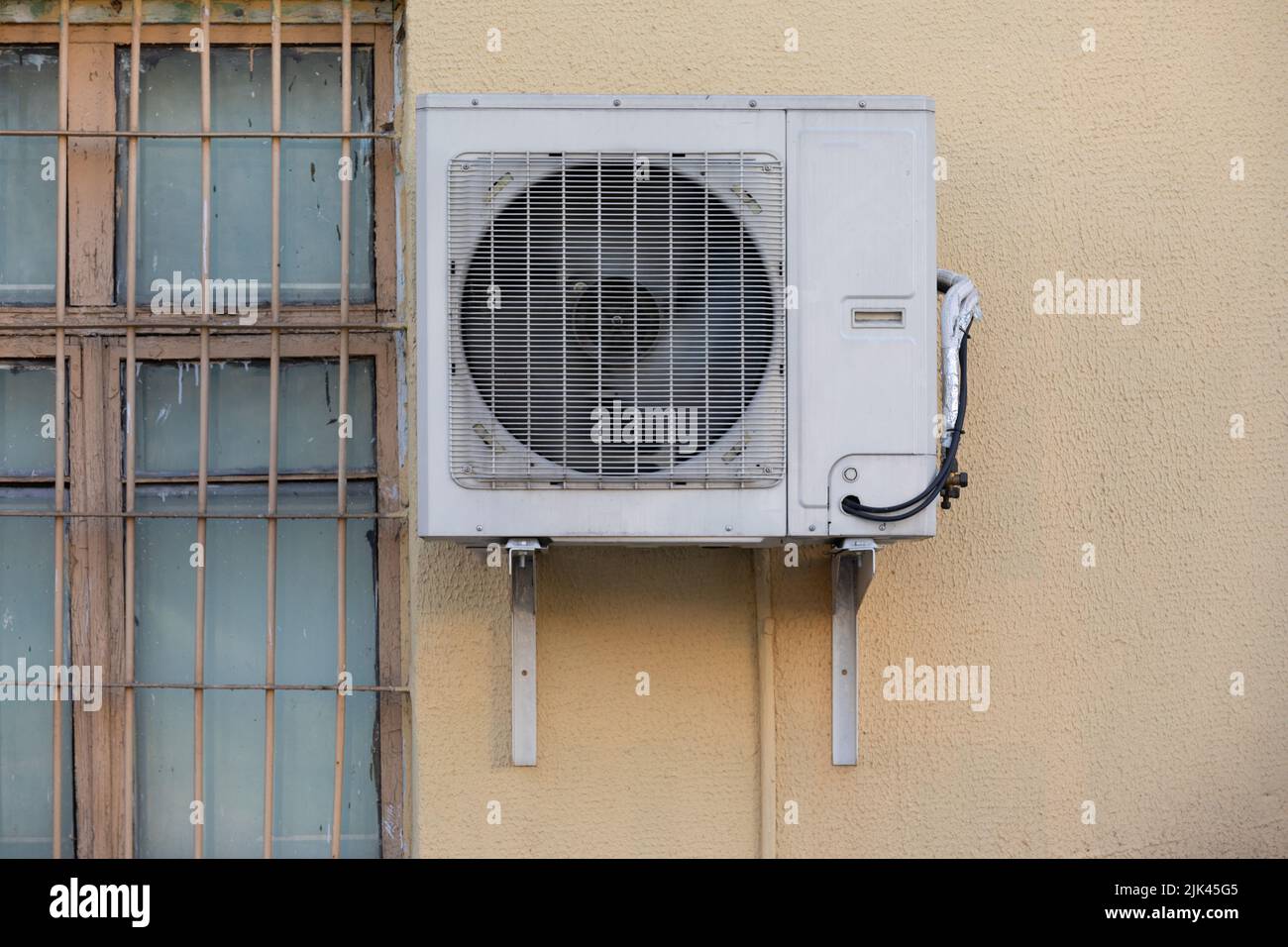 old outdoor air conditioner unit hanging outside the building Stock ...
