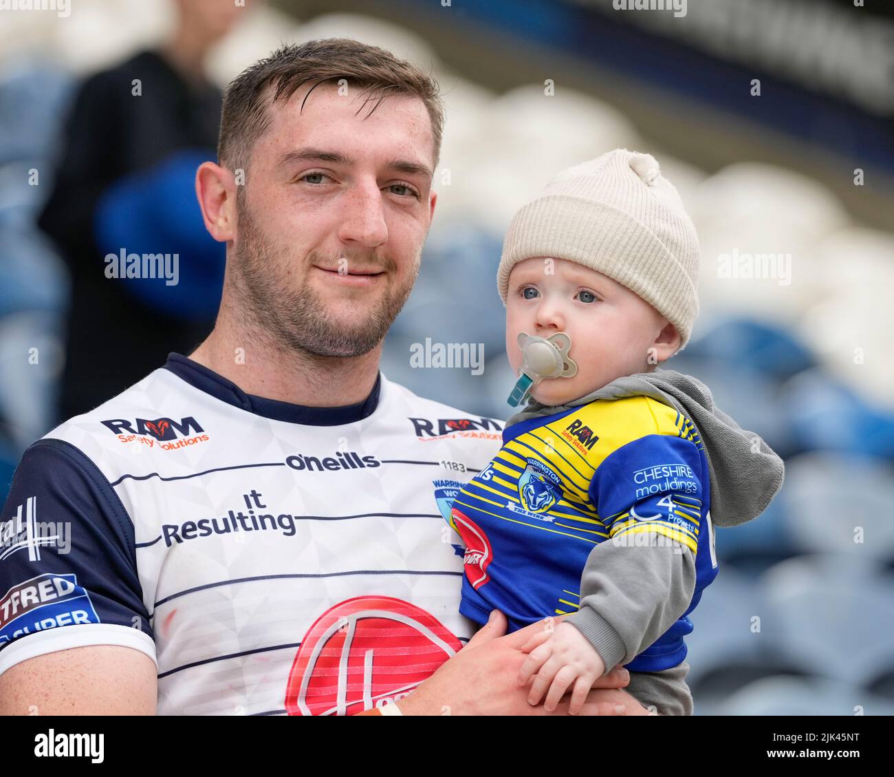 Jake Wardle #34 of Warrington Wolves with his young child after the ...