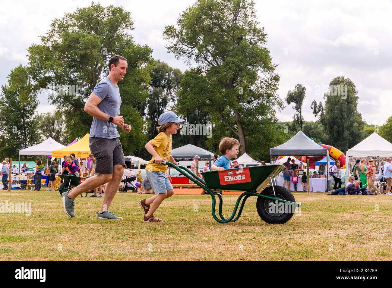 Competitors in a wheelbarrow race at the Damerham Fair and ...