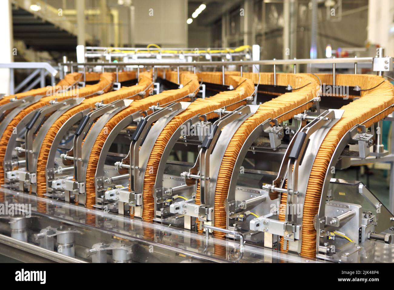Large biscuit factory. A line of biscuits in a large factory. Packing ...