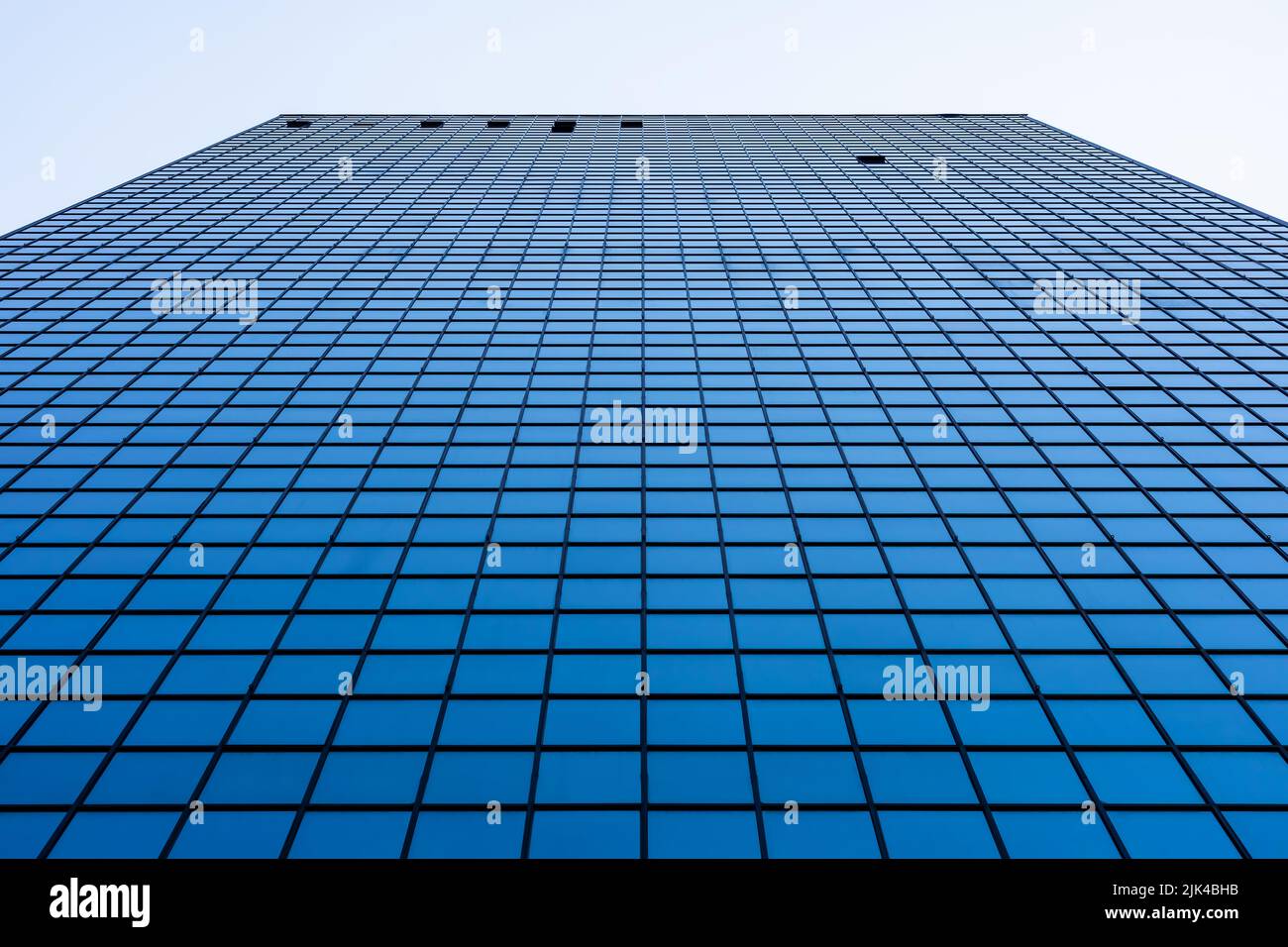 Perspective of the facade of a modern skyscraper with large reflected ...