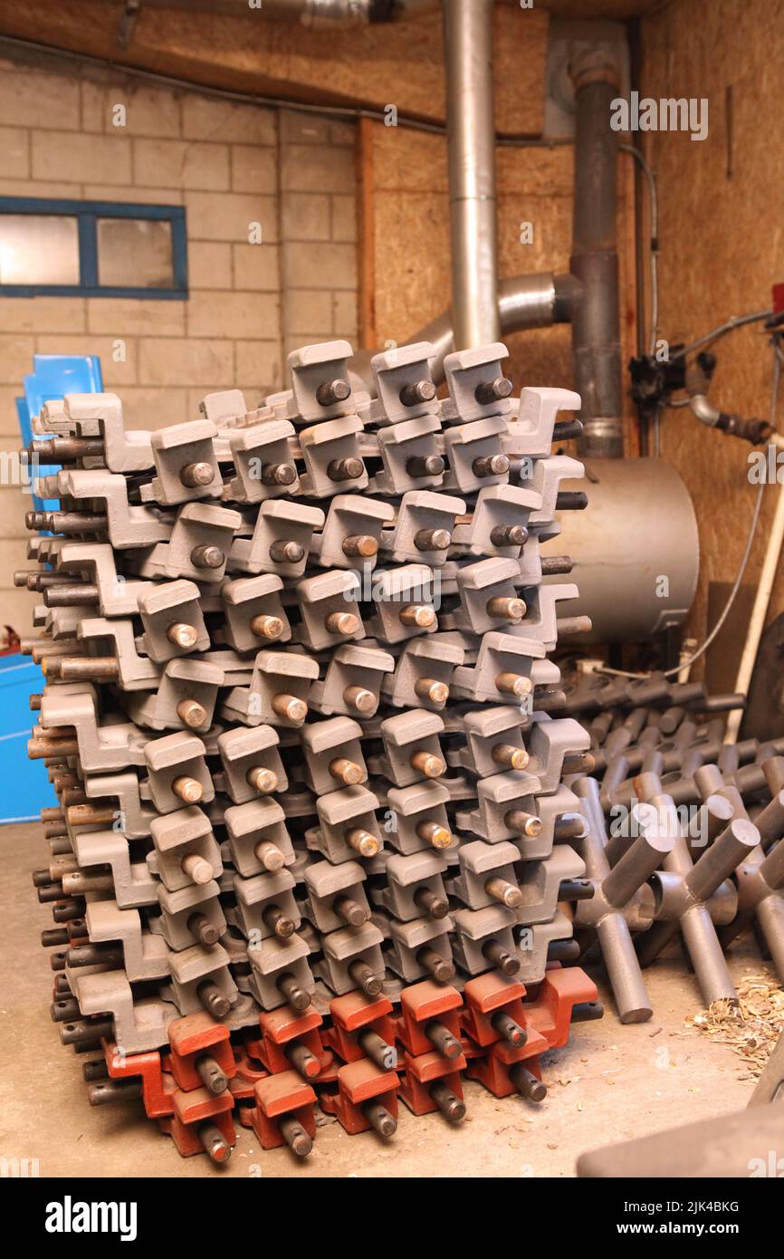 Lots of parts for big cars. Gears, shafts, sprockets in large ...