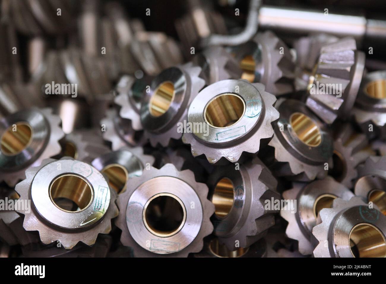 Lots of parts for big cars. Gears, shafts, sprockets in large ...