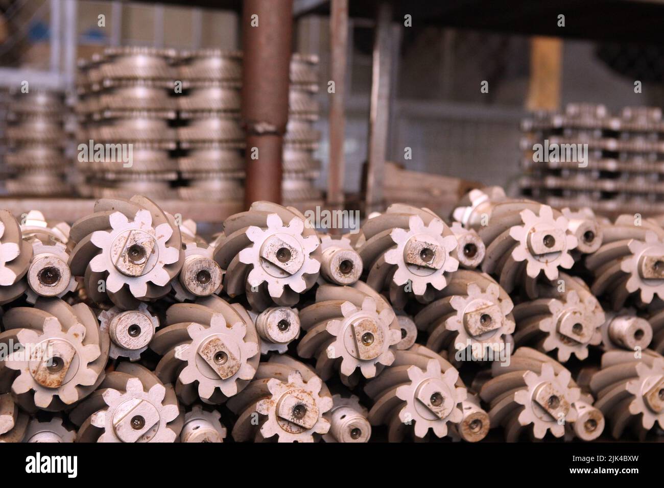 Lots of parts for big cars. Gears, shafts, sprockets in large ...