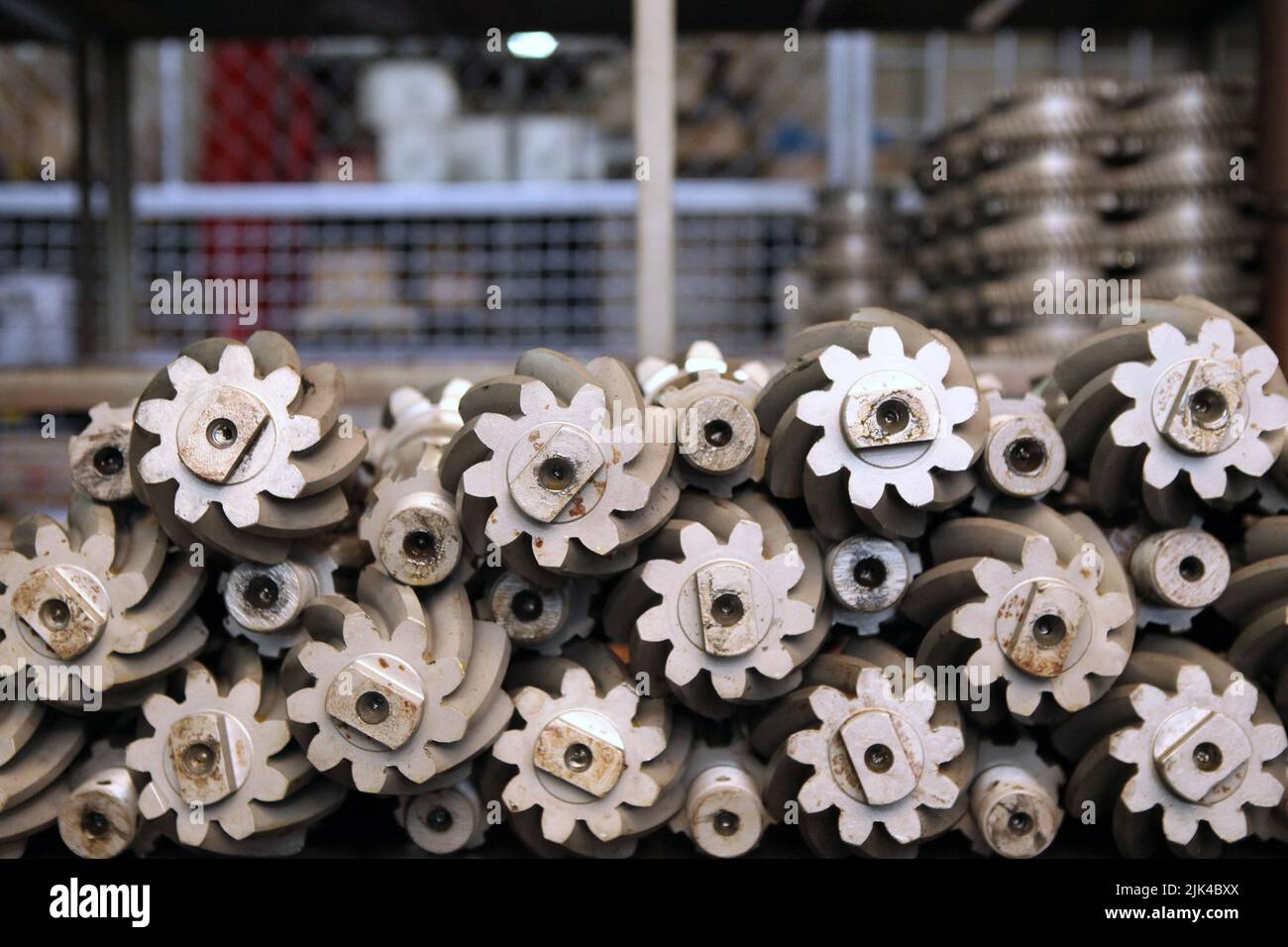 Lots of parts for big cars. Gears, shafts, sprockets in large ...