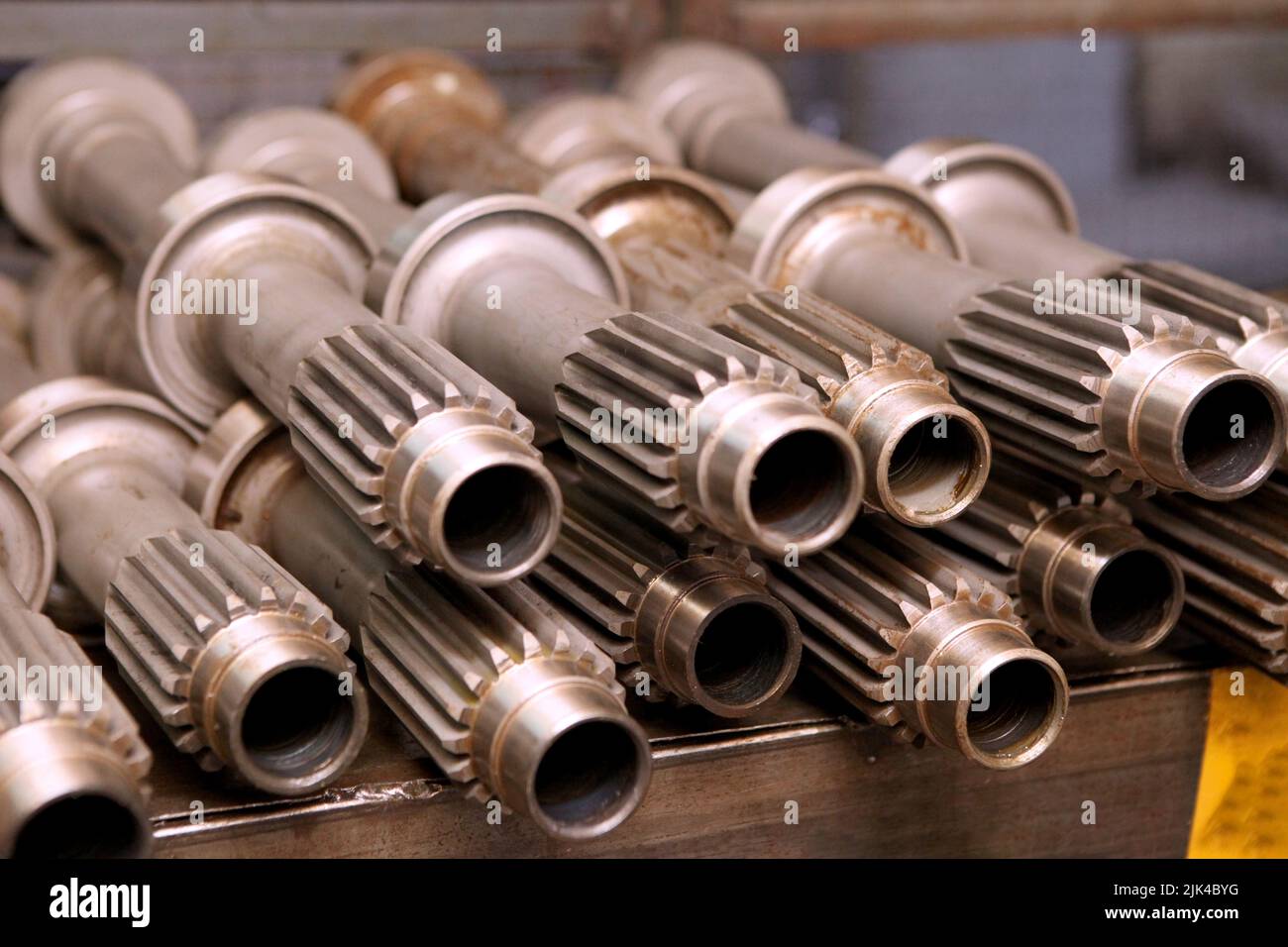 Lots of parts for big cars. Gears, shafts, sprockets in large ...