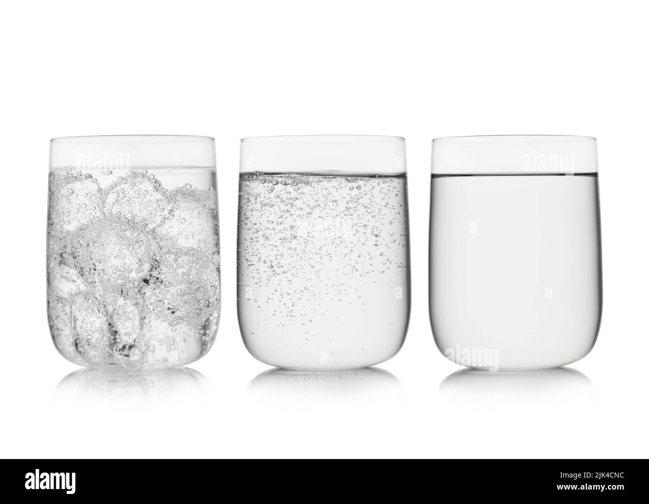 Sparkling mineral water and still water in large glasses with ice cubes on white background ...