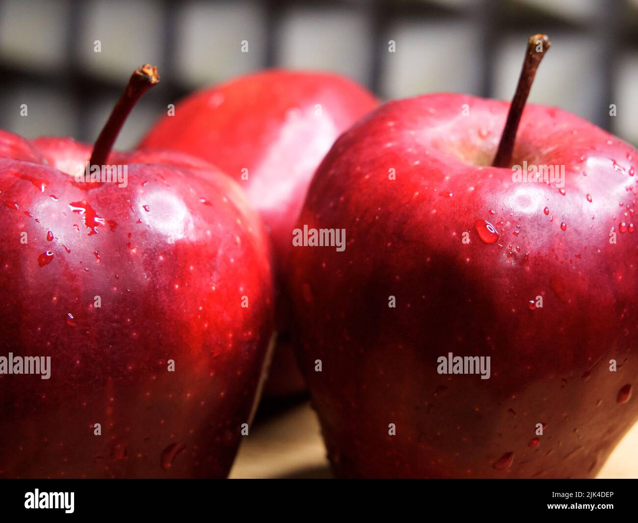Three large red apples of the Red Chief variety. Water droplets on ...