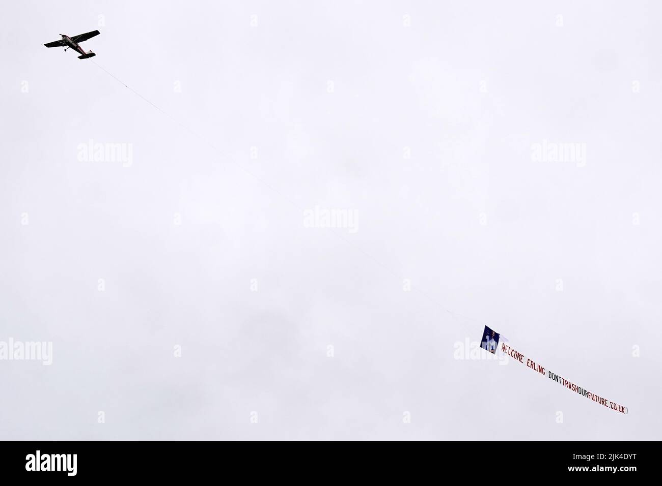 An aircraft flying over the stadium with a banner welcoming Manchester ...