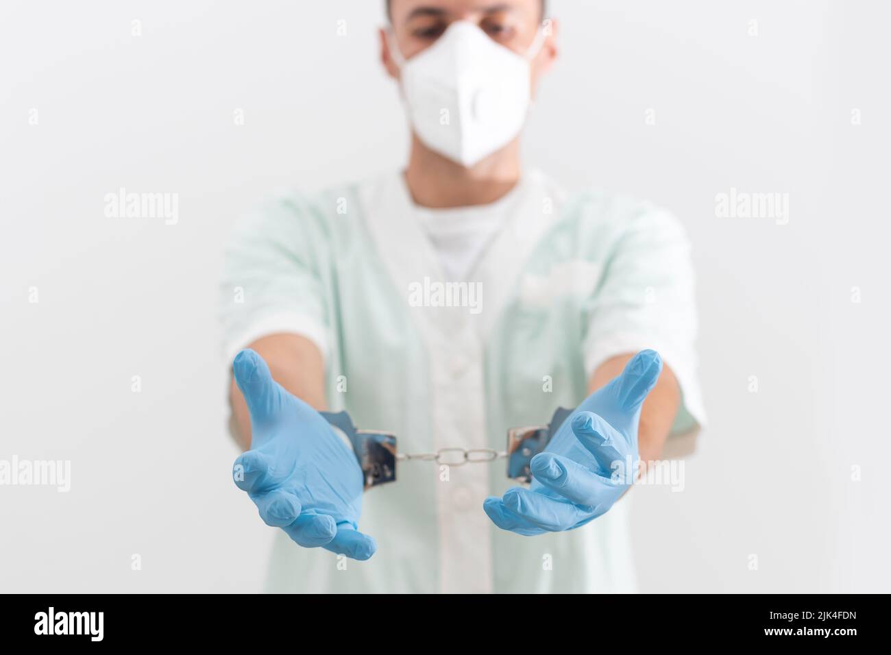 Corona virus prevention face masks at home. Hands in handcuffs medical ...