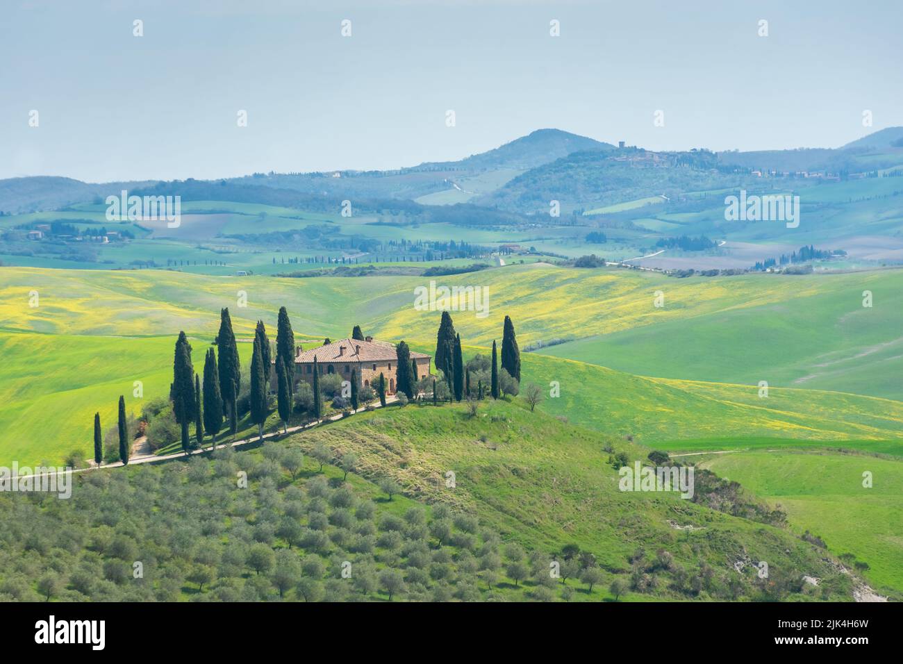 Lonely farm upon a hill in the meadows of Tuscany, Italy Stock Photo ...