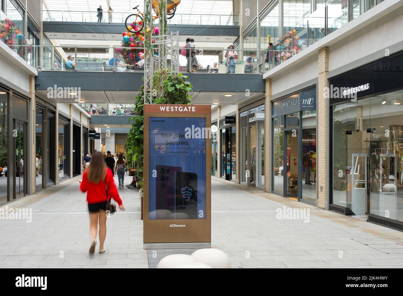 Interior of Westgate Shopping Centre with people walking past retail ...