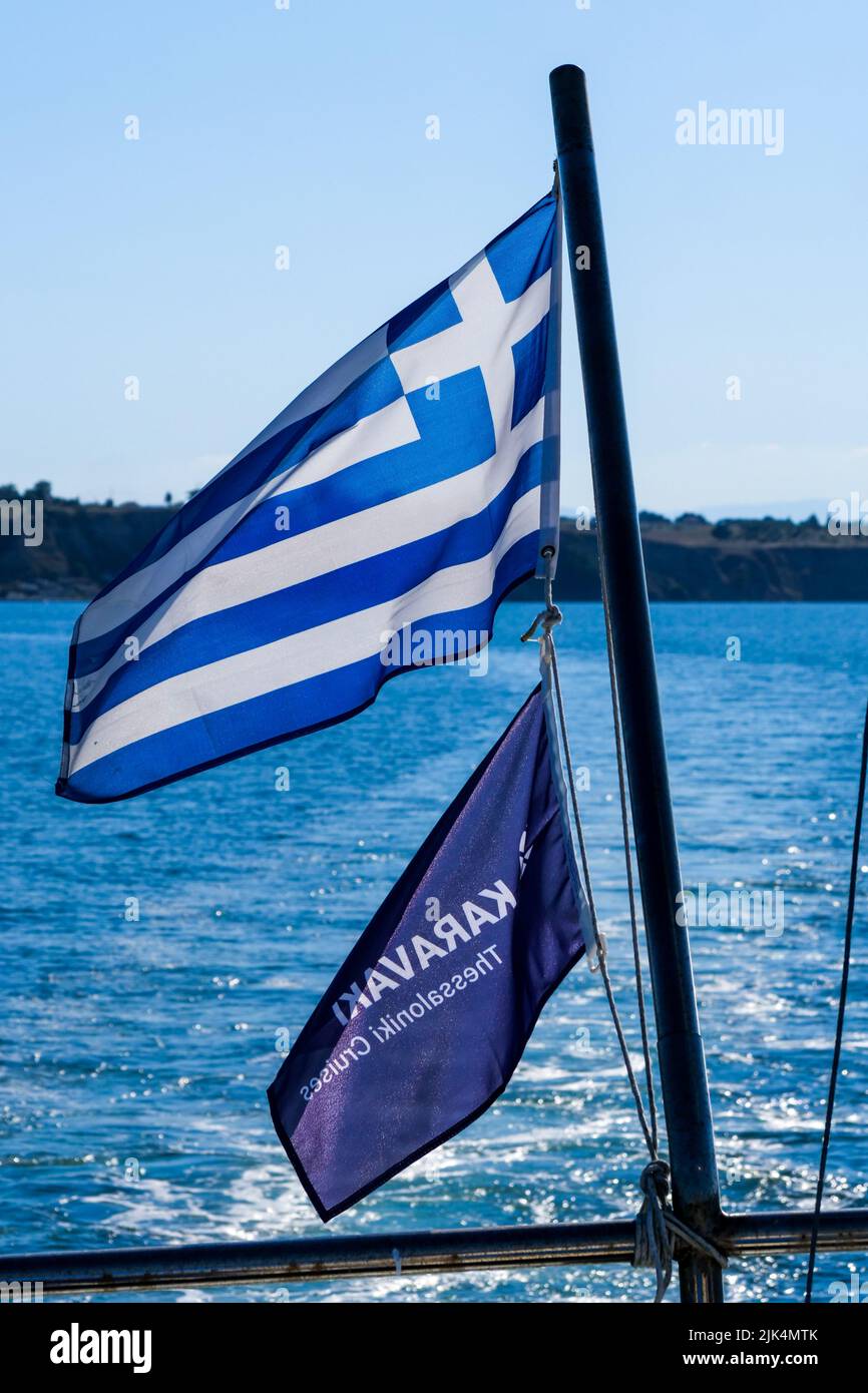 Greek flag waving over the stern of a cruise ship, Aghia Triada area ...