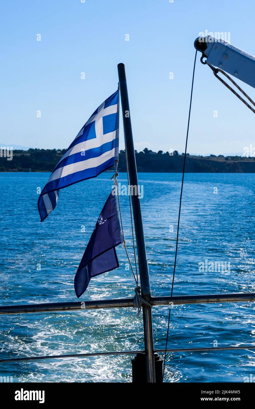 Greek flag waving over the stern of a cruise ship, Aghia Triada area ...