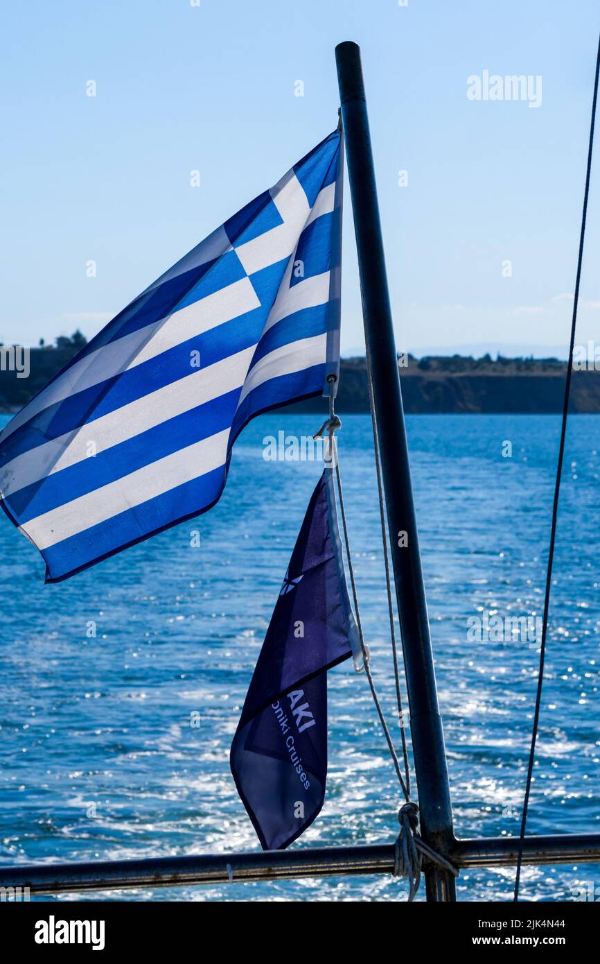Greek flag waving over the stern of a cruise ship, Aghia Triada area ...