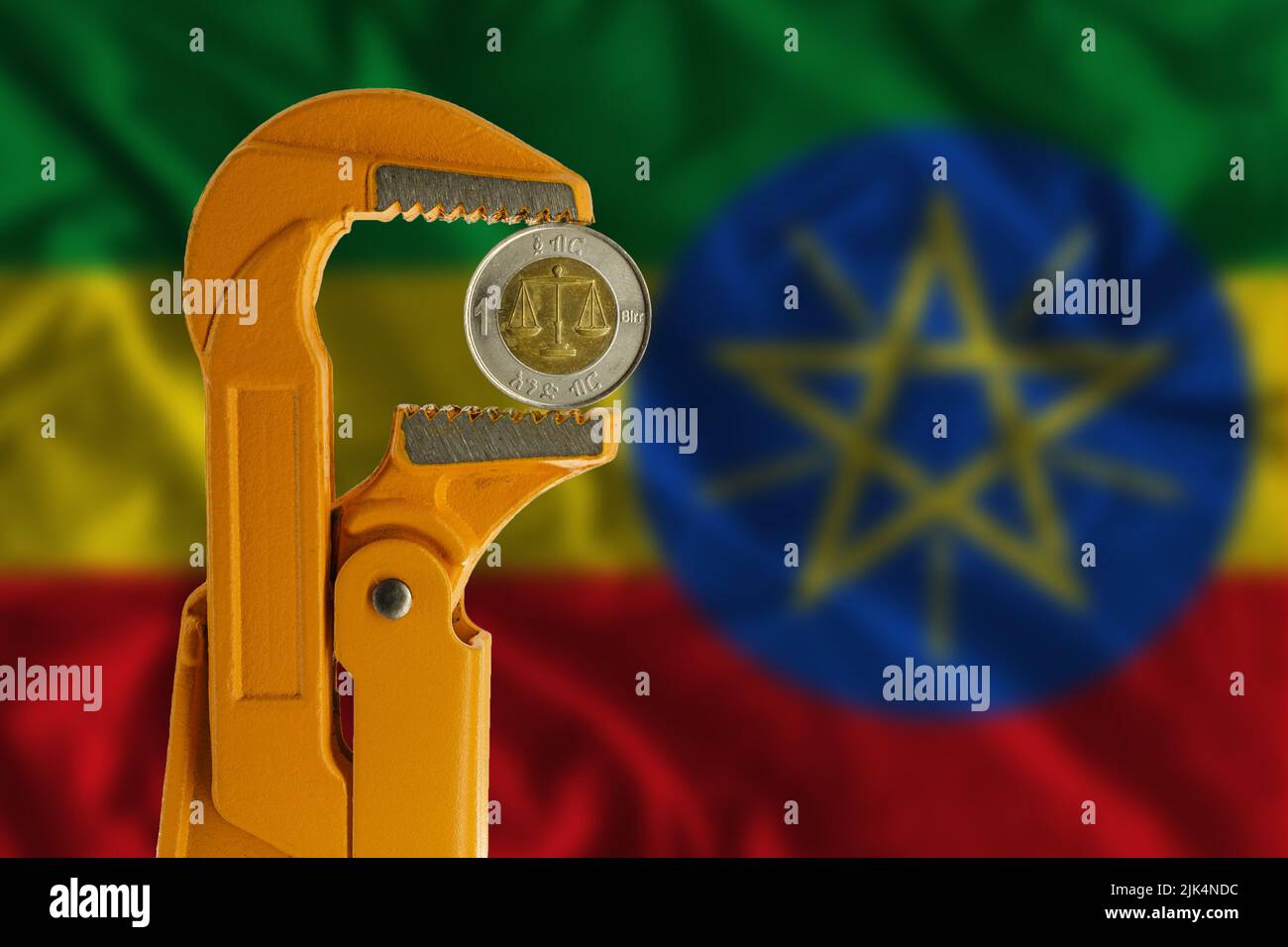 Ethiopian one Birr coin held in an orange plumber wrench on the ...