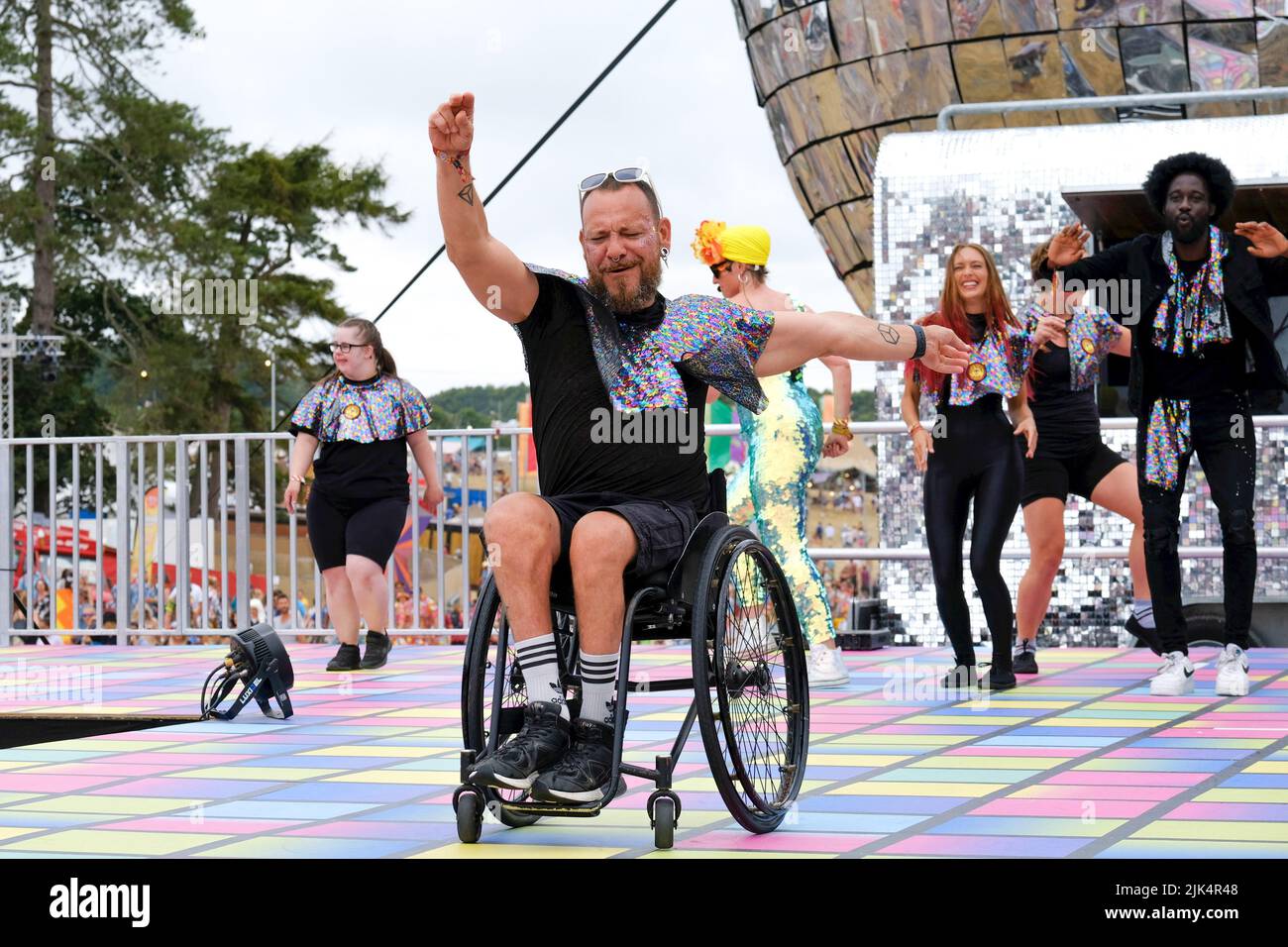 A member of dance troupe Diverse City in a wheel chair performs on a ...