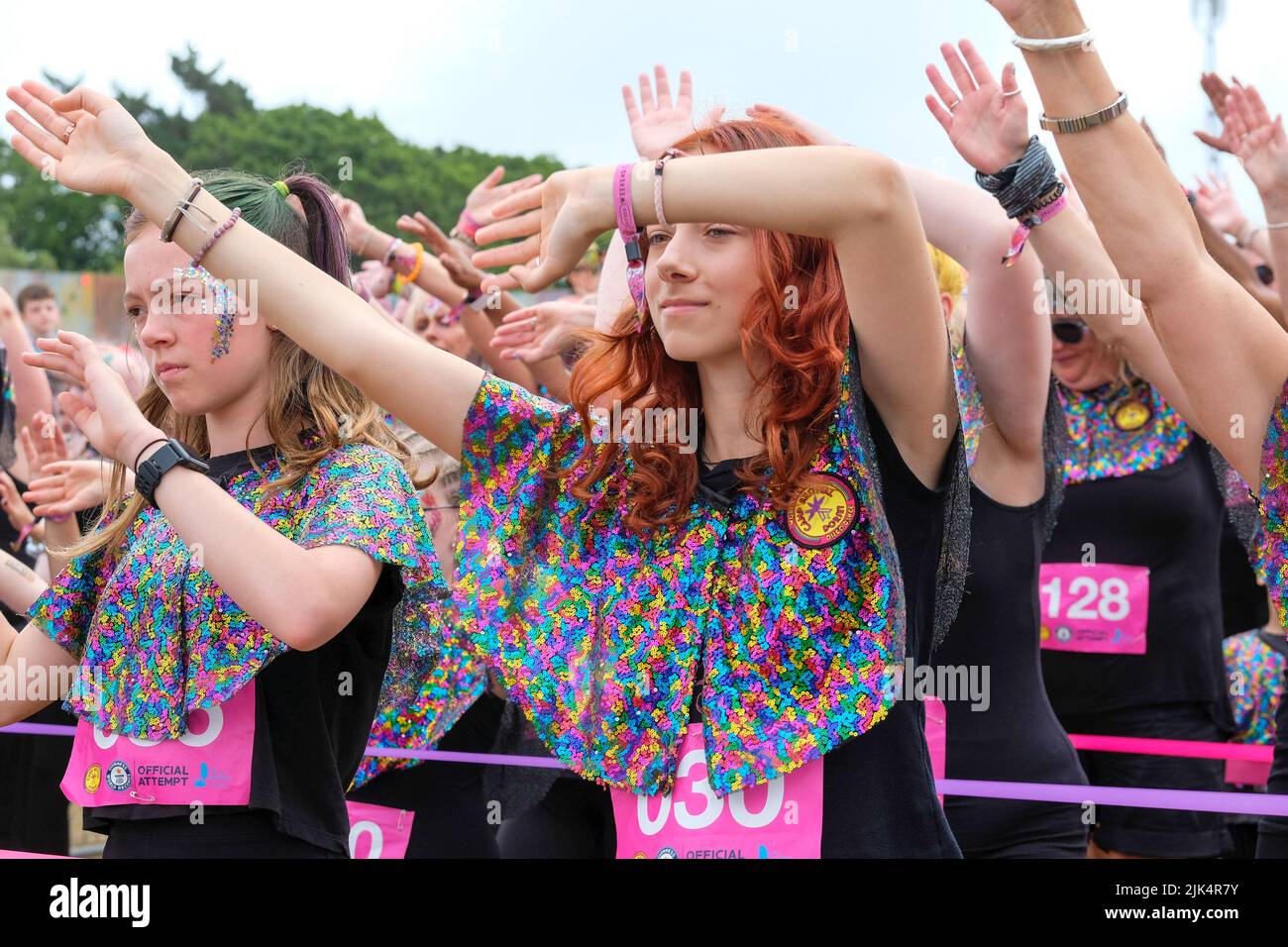 Lulworth, UK. 30th July, 2022. Crowd of people dance with dance troupe ...