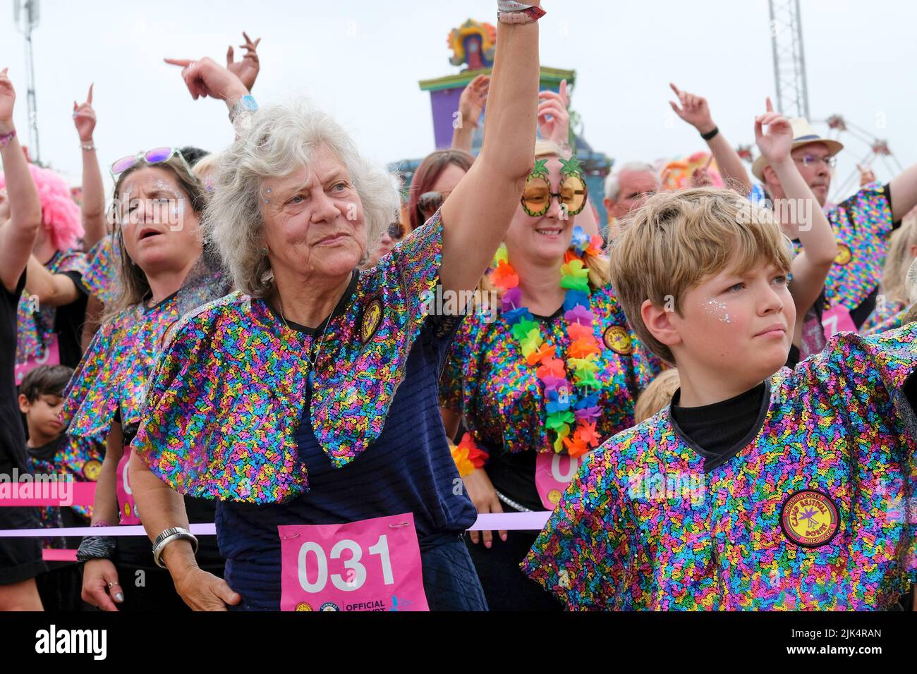 Lulworth, UK. 30th July, 2022. Crowd of people dance with dance troupe ...