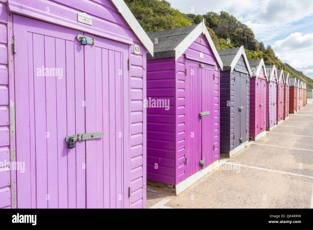 row of multicoloured wooden beach huts by the sea in Bournemouth Dorset ...