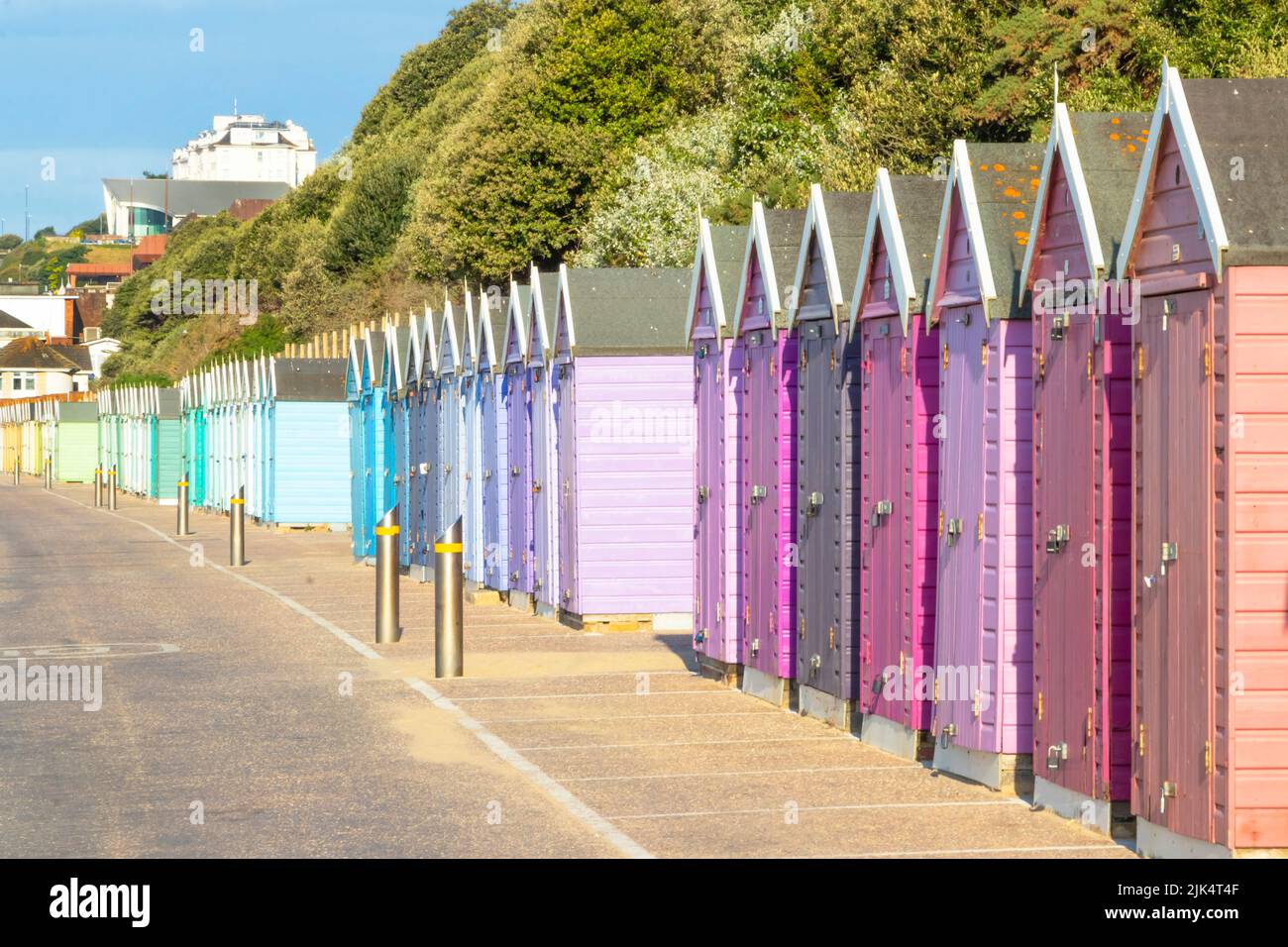 row of multicoloured wooden beach huts by the sea in Bournemouth Dorset ...