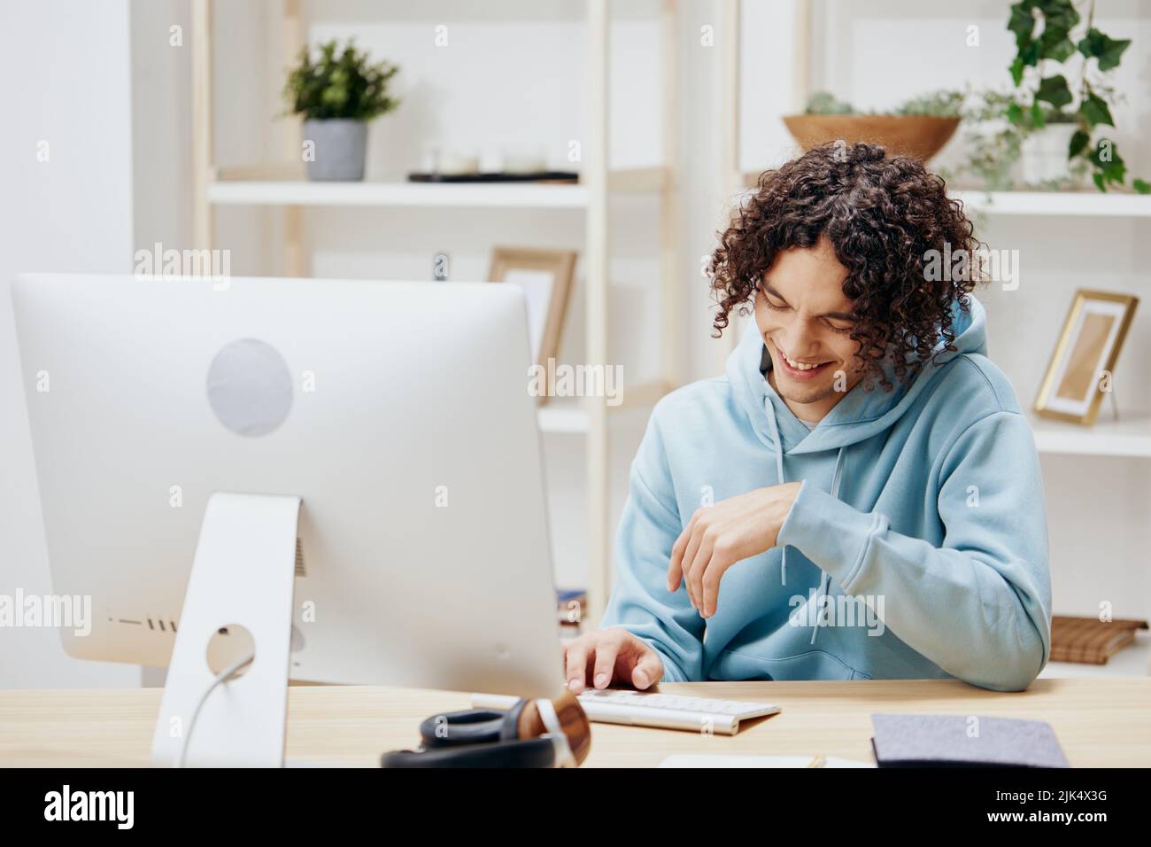 handsome guy in a blue jacket in front of a computer Lifestyle Stock ...