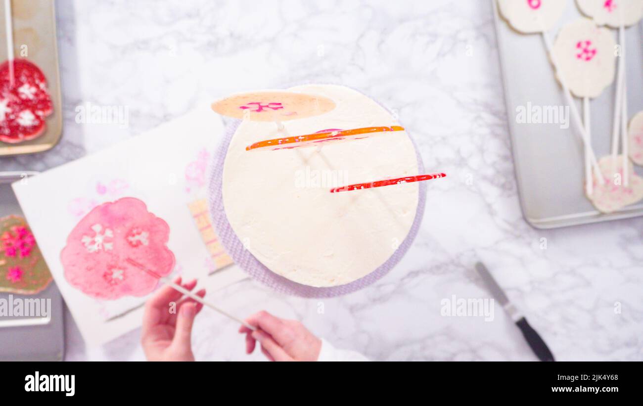 Flat lay. Inserting large lollipops with snowflakes into the tall white ... Flat lay. Inserting large lollipops with snowflakes into the tall white ...