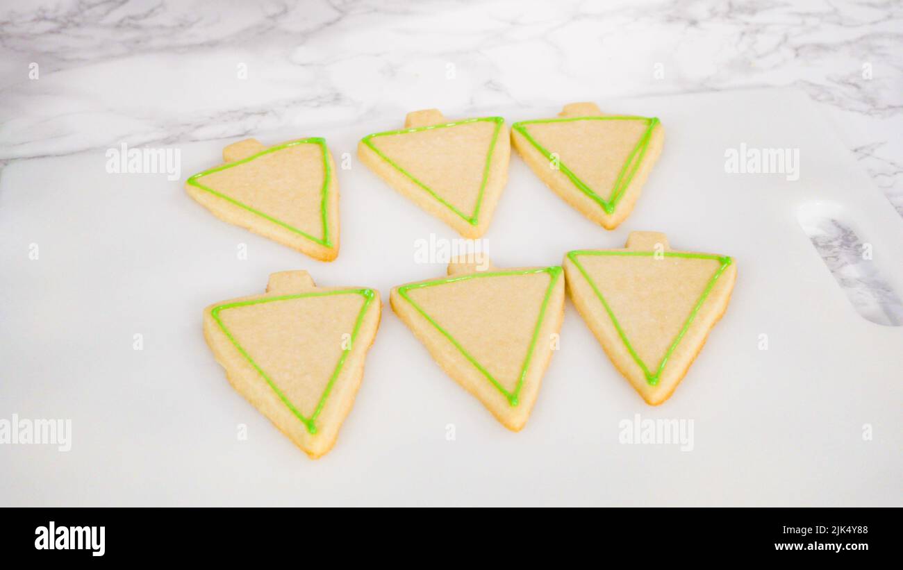 Stp by step. Icing Christmas tree-shaped sugar cookies with green royal ...