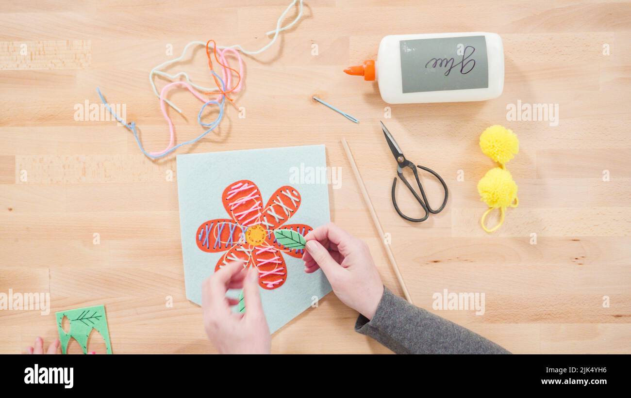 Mother teaching kids how to sew with simple sewing kit at the craft ...