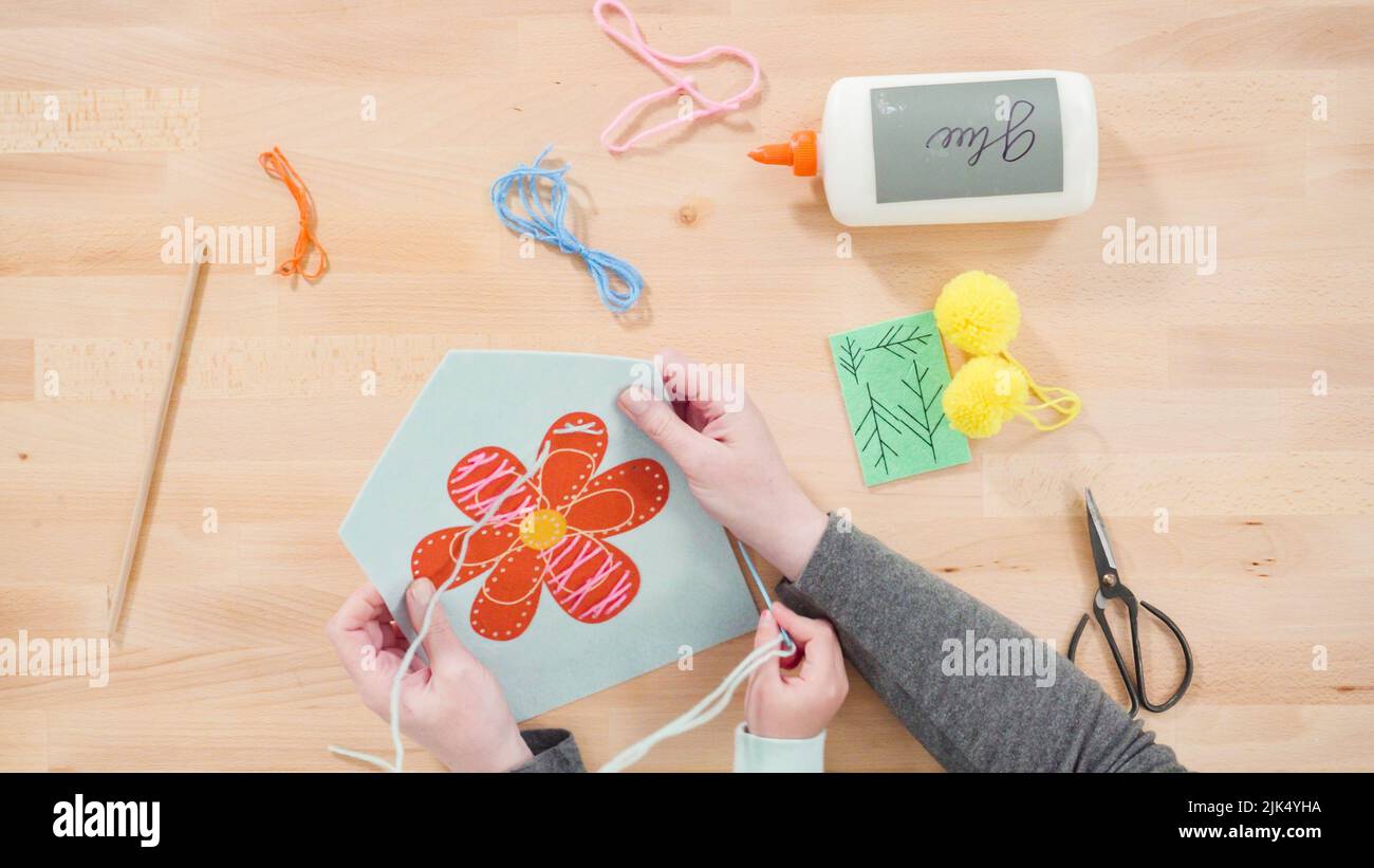 Mother teaching kids how to sew with simple sewing kit at the craft ...