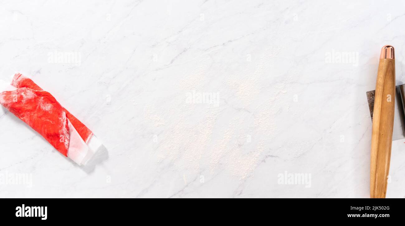 Flat lay. Rolling red and blue bread dough to bake patriotic cinnamon ...