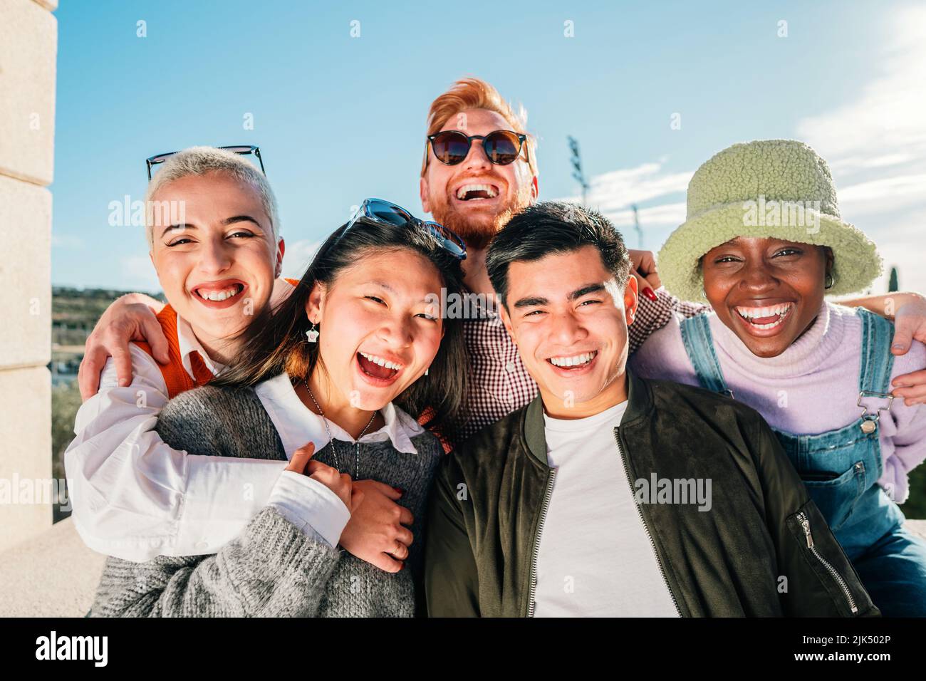 Five multi-ethnic friends posing for a photo smiling and having fun ...