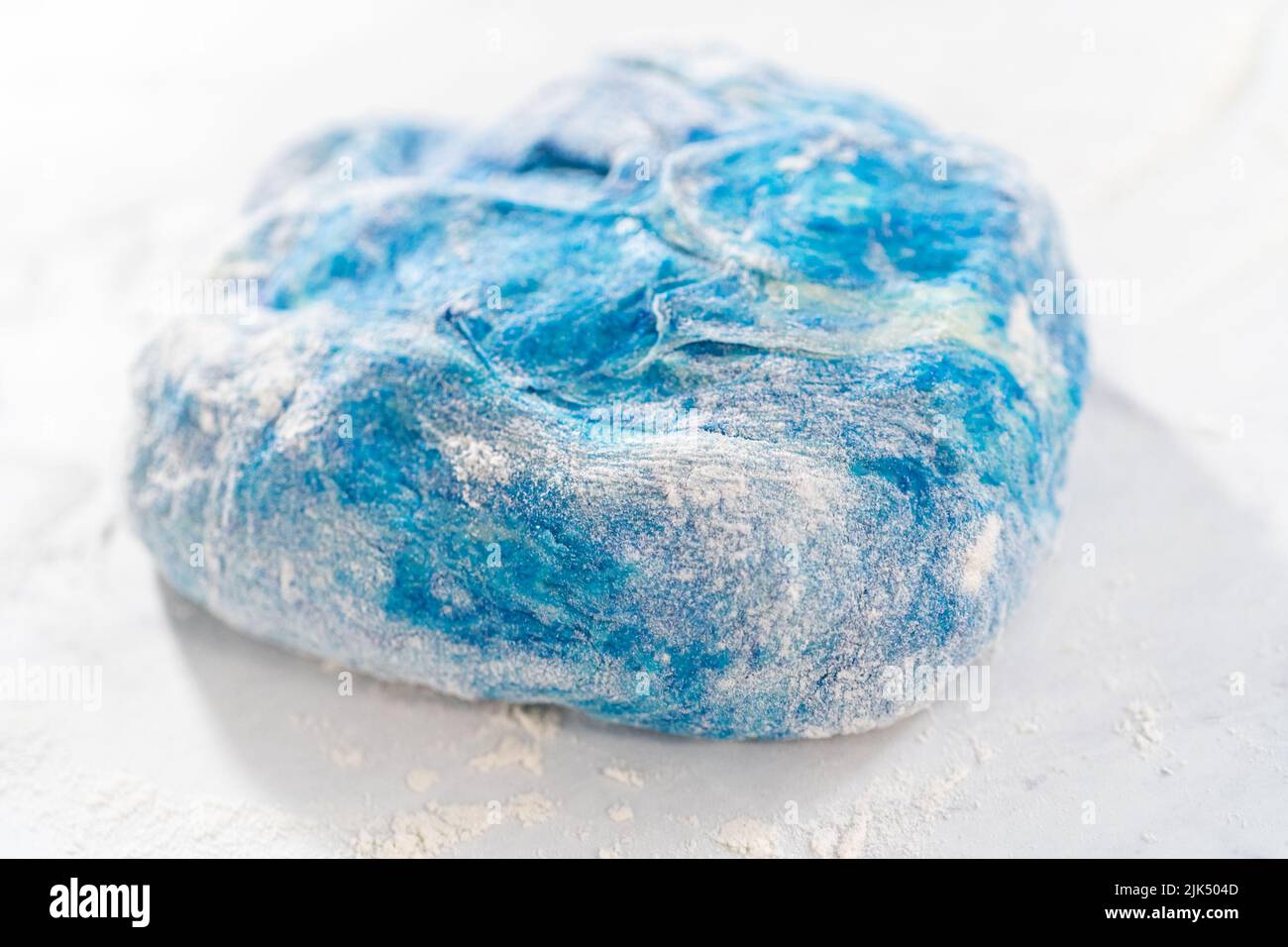 Rolling red and blue bread dough to bake patriotic cinnamon twists ...