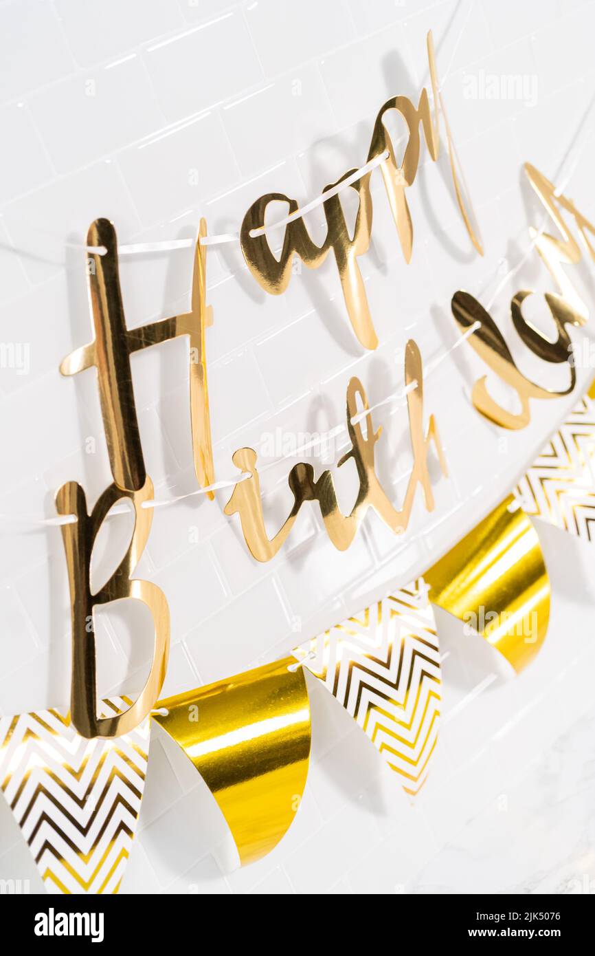 Paper Happy Birthday gold paper banner in the kitchen Stock Photo - Alamy