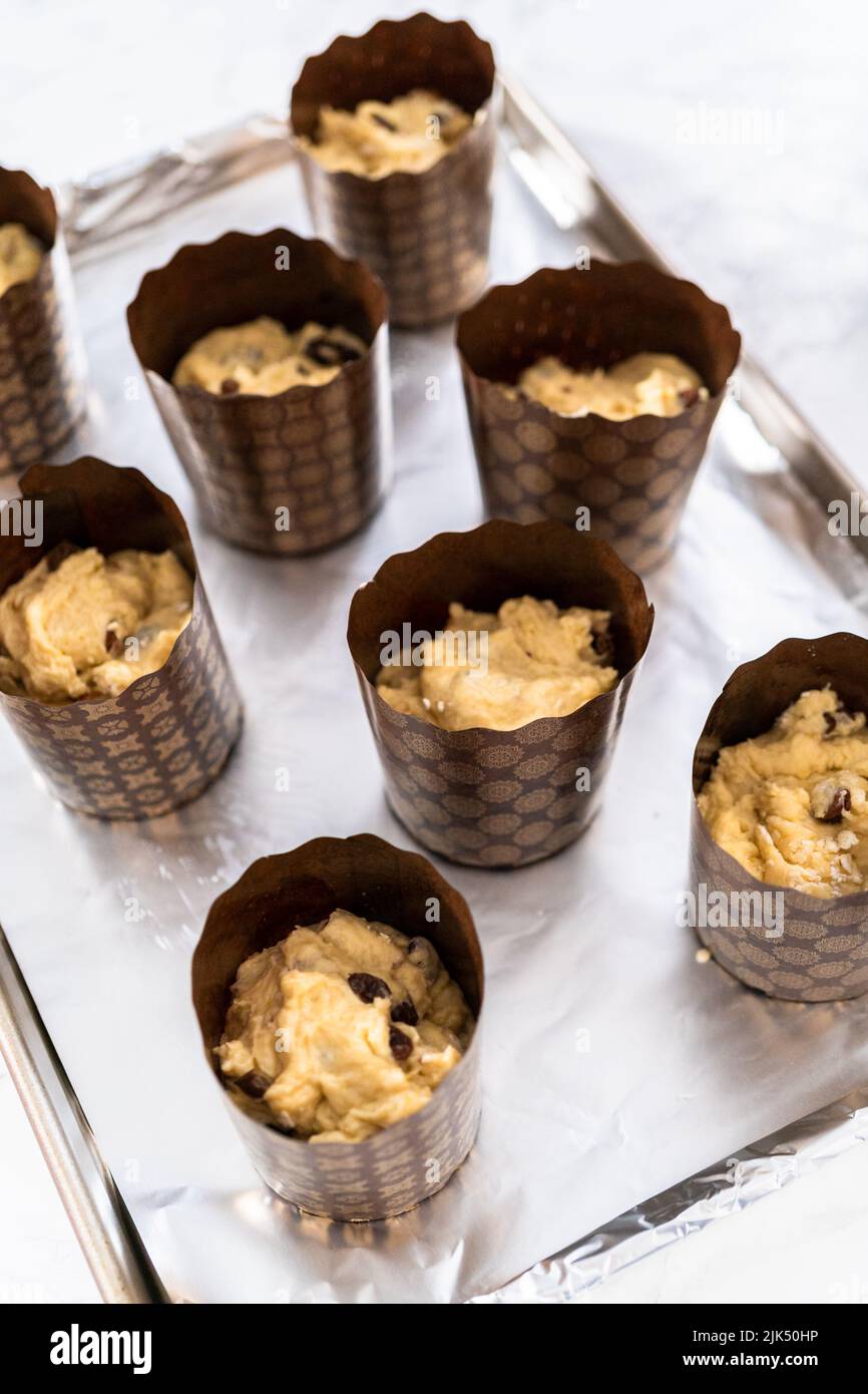 Rising dough in paper liners to bake mini Easter bread kulich Stock Photo - Alamy