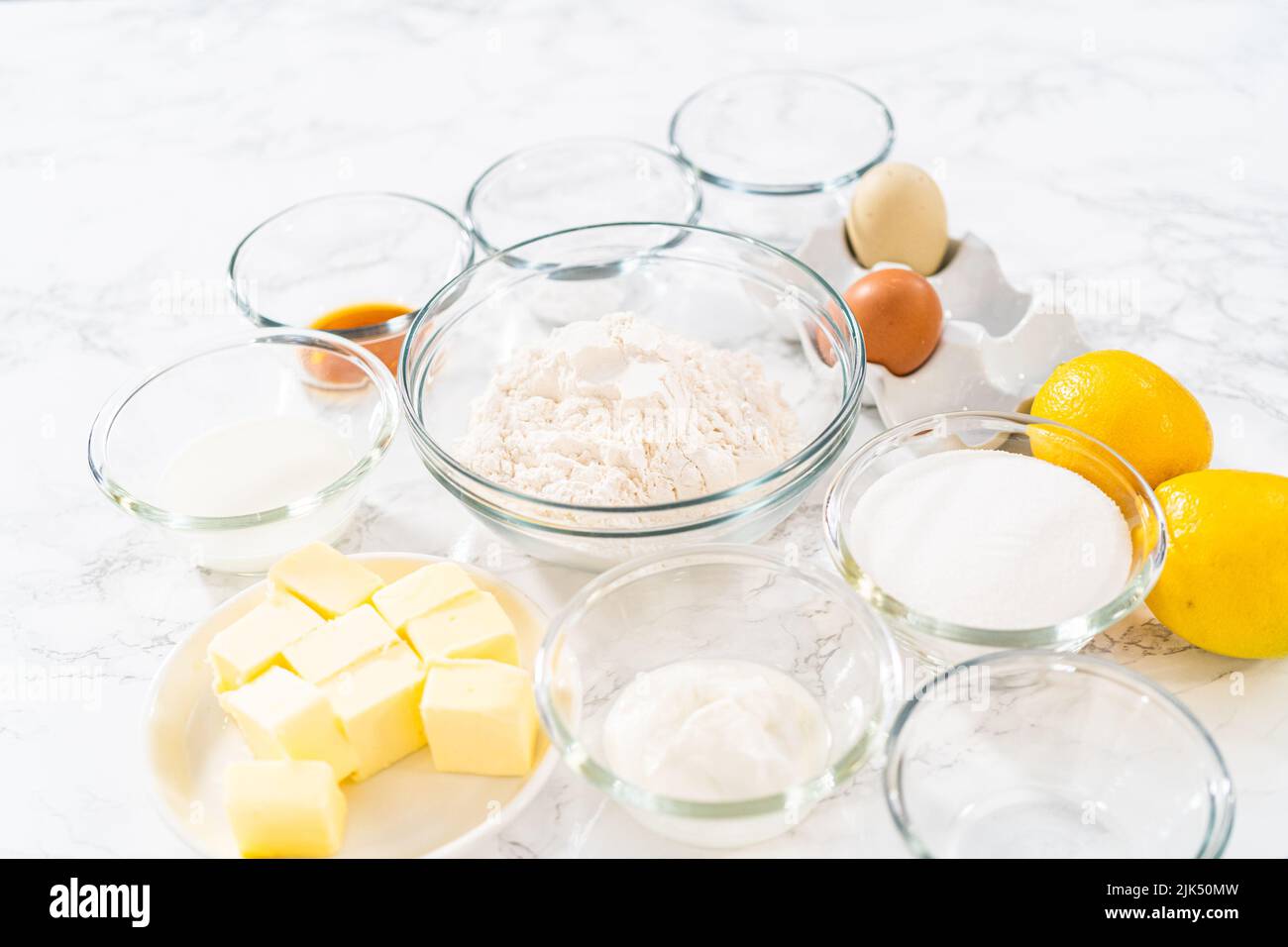 Measured ingredients in glass mixing bowls to make lemon cupcakes Stock ...