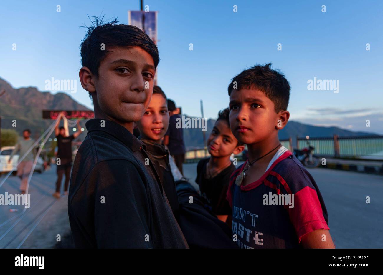 Kashmiri kids pose for a pictures as they participate in hoisting flags ...