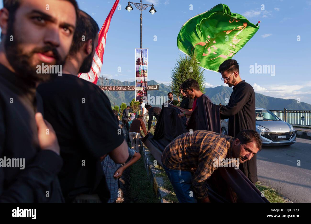 Srinagar, India. 30th July, 2022. Kashmiri Shia Muslims hoisting ...