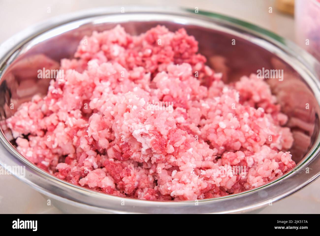 A man mixes minced meat in a bowl with his hands. Preparation of minced ...