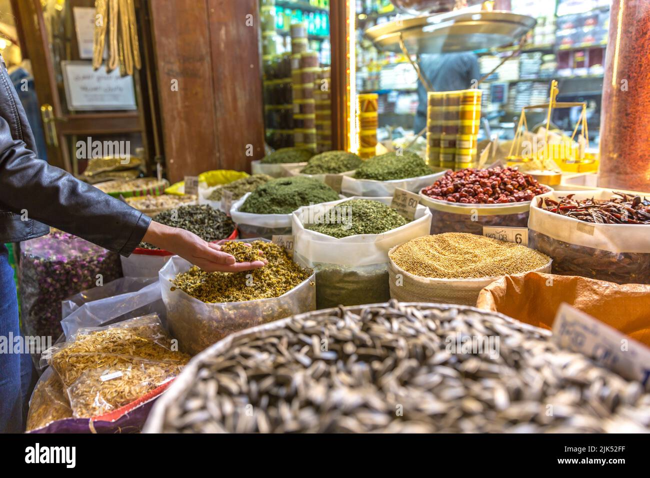 Woman buying herbs and spices in a traditional street market in Doha ...