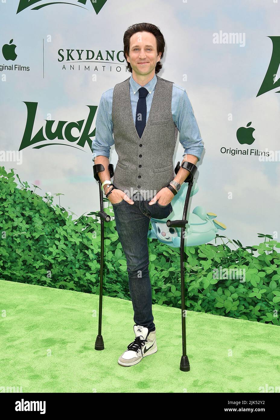 Josh Sundquist walking on the red carpet at the global premiere of the Apple Original Film "Luck ...