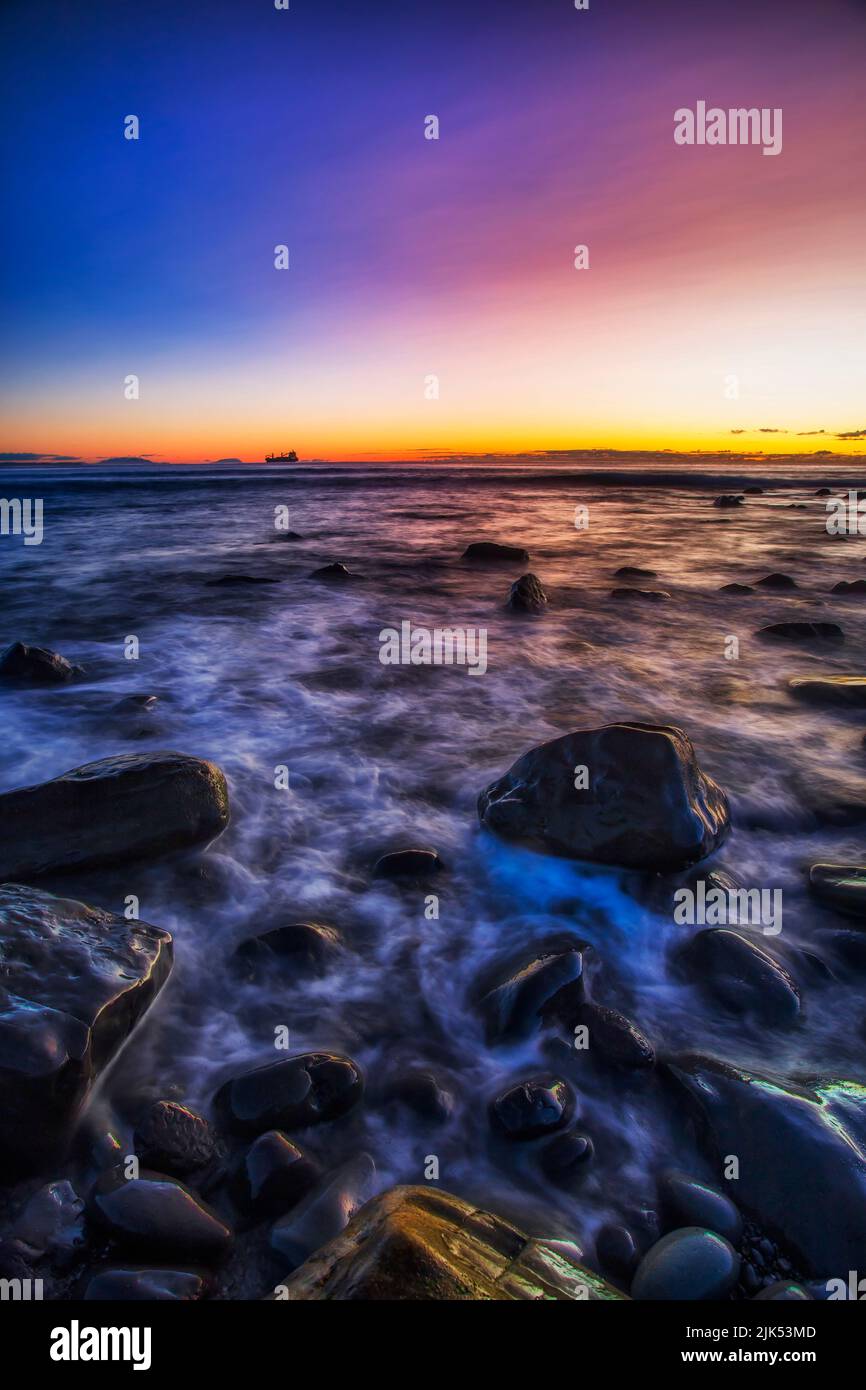 Pebbly beach in Forster town on PAcific coast at sunrise - scenis ...