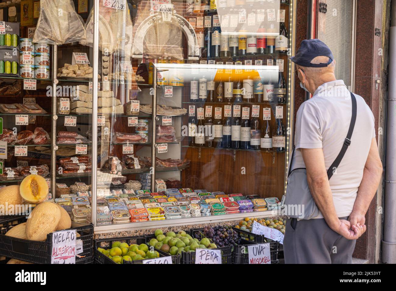OPORTO, PORTUGAL - 28.07.2022: Man looking at traditional food store ...