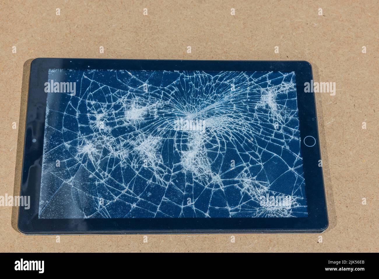 View of electronic tablet with damaged screen isolated on gray ...