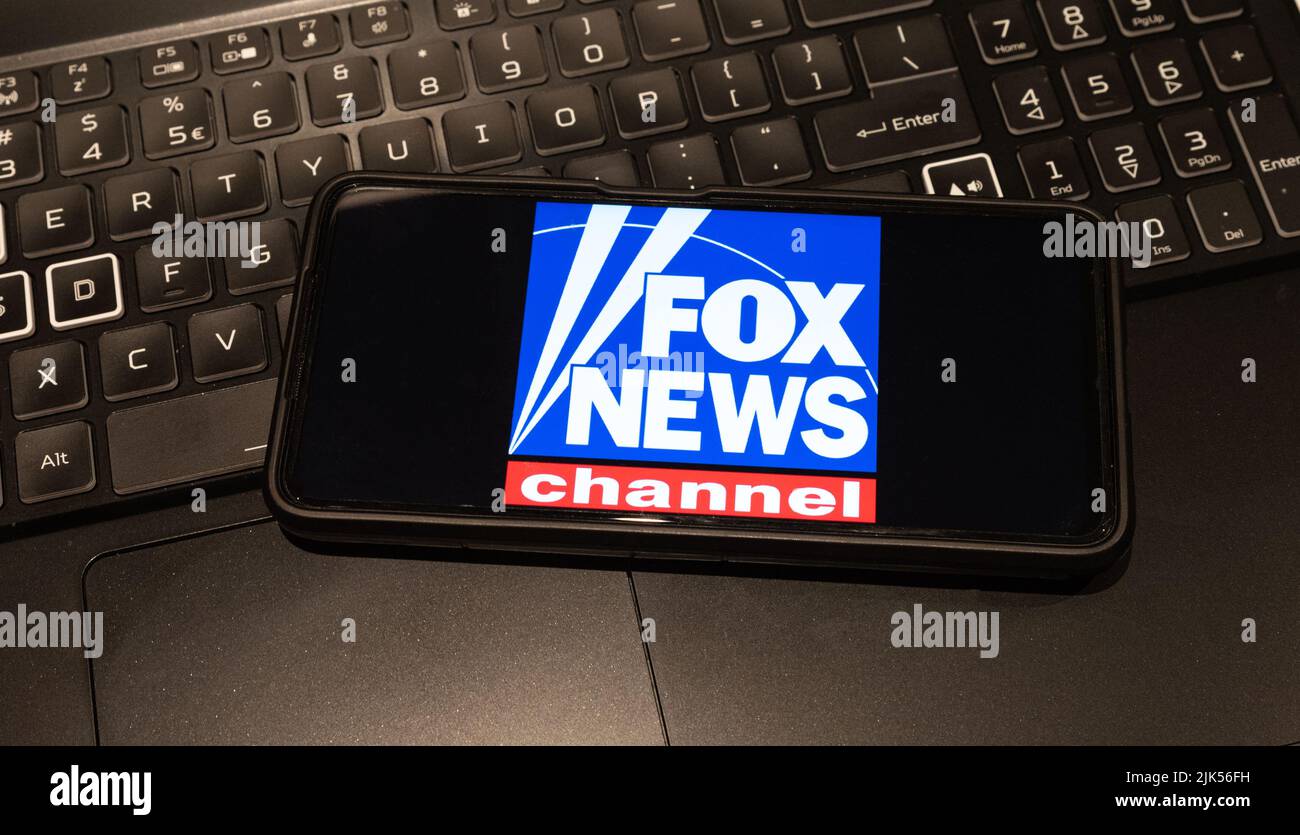 fox news channel logo on mobile phone , background is a keyboard ...