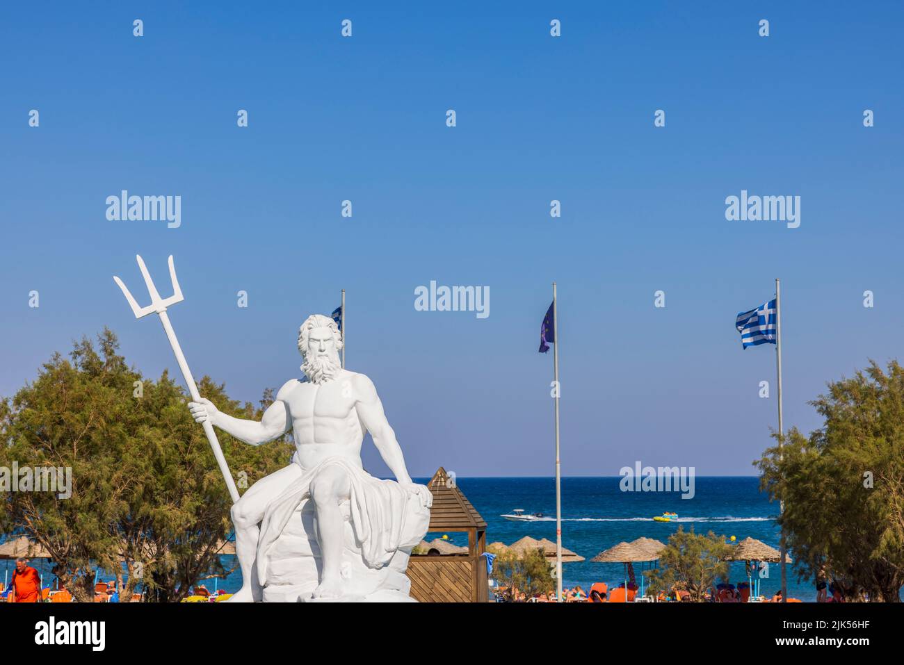 Beautiful view of Poseidon sculpture on Greek flags and blue sky ...