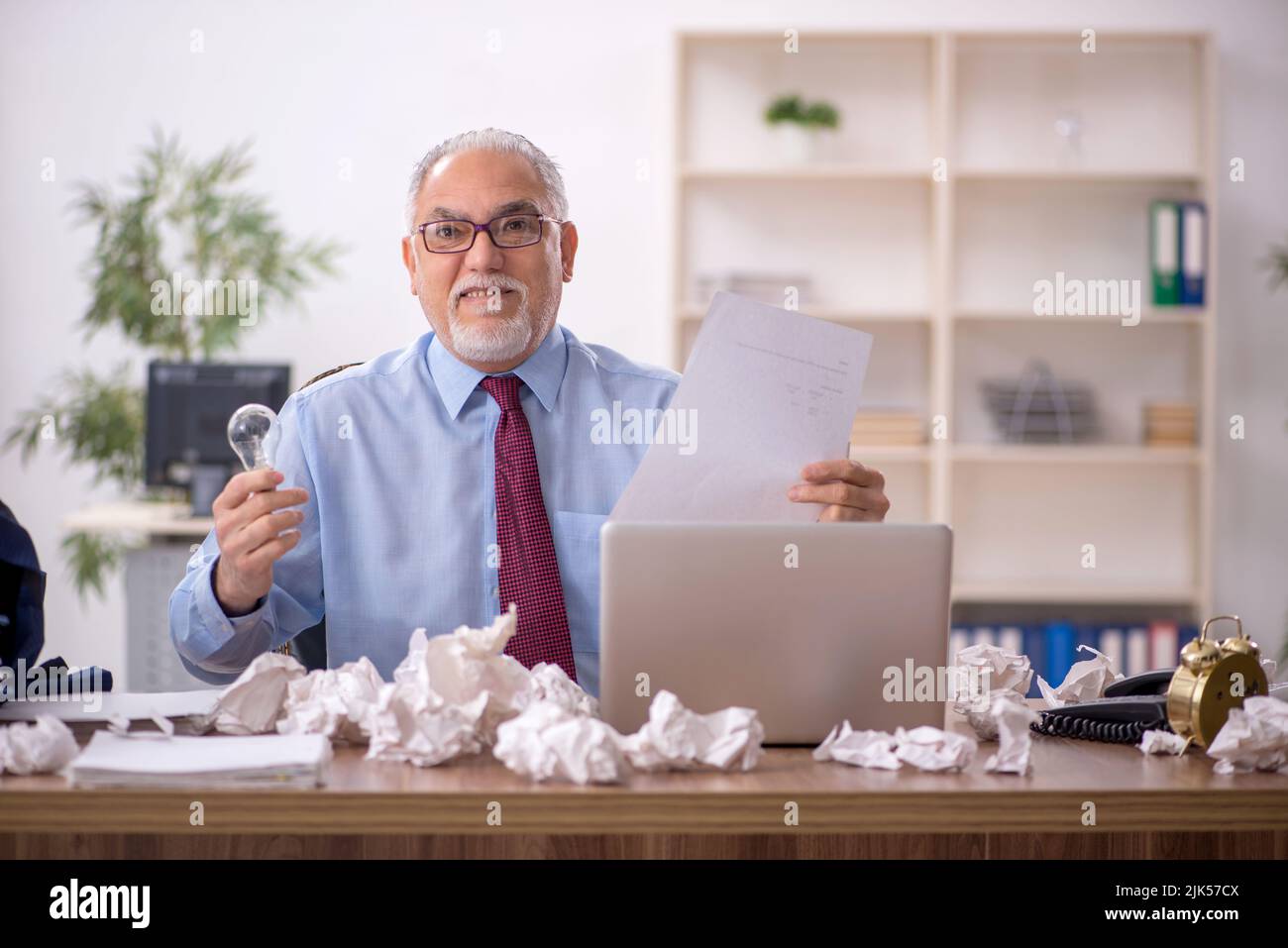 Old businessman employee in brainstorming concept Stock Photo - Alamy