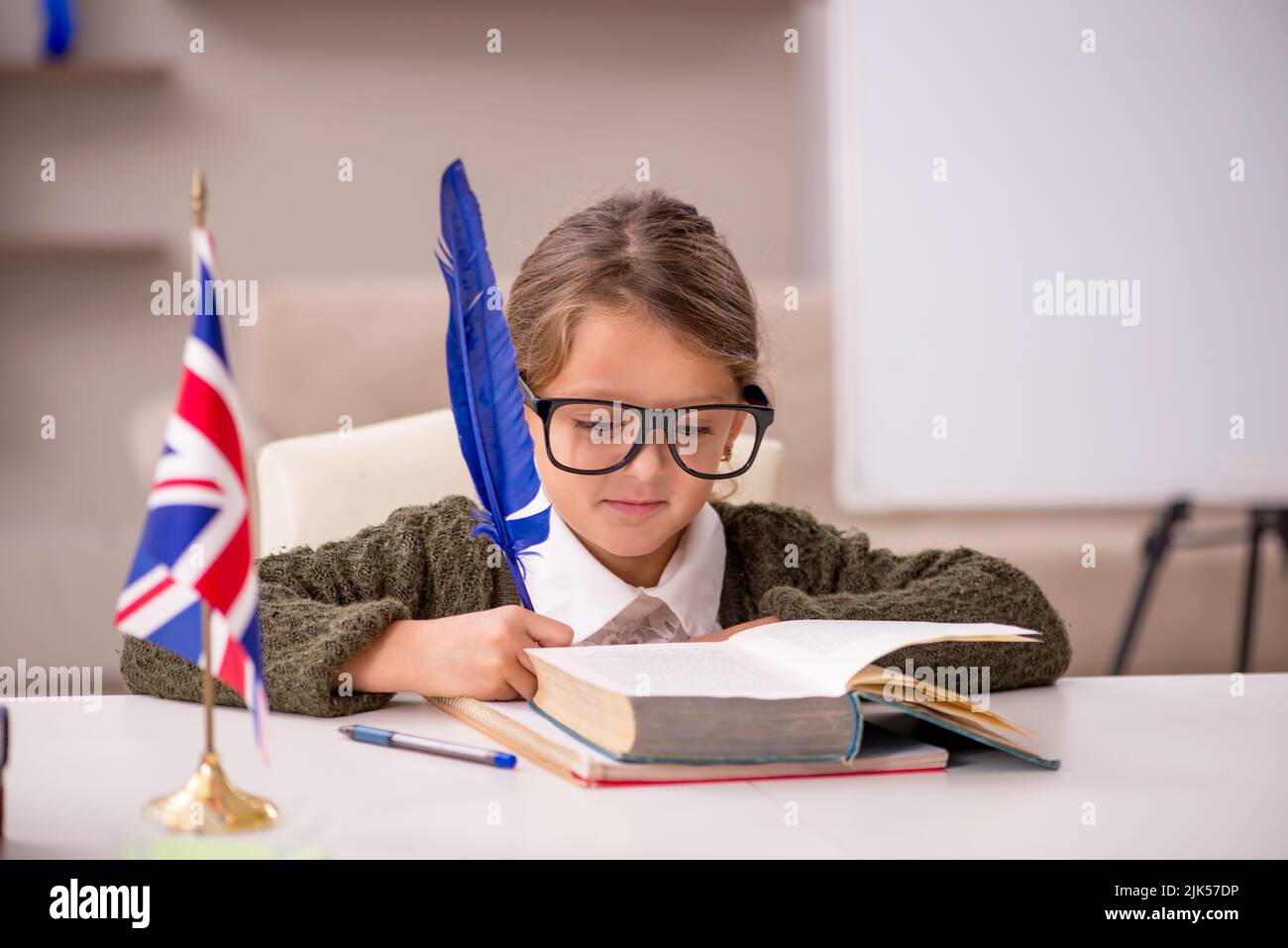 Young small girl studying english language at home Stock Photo - Alamy